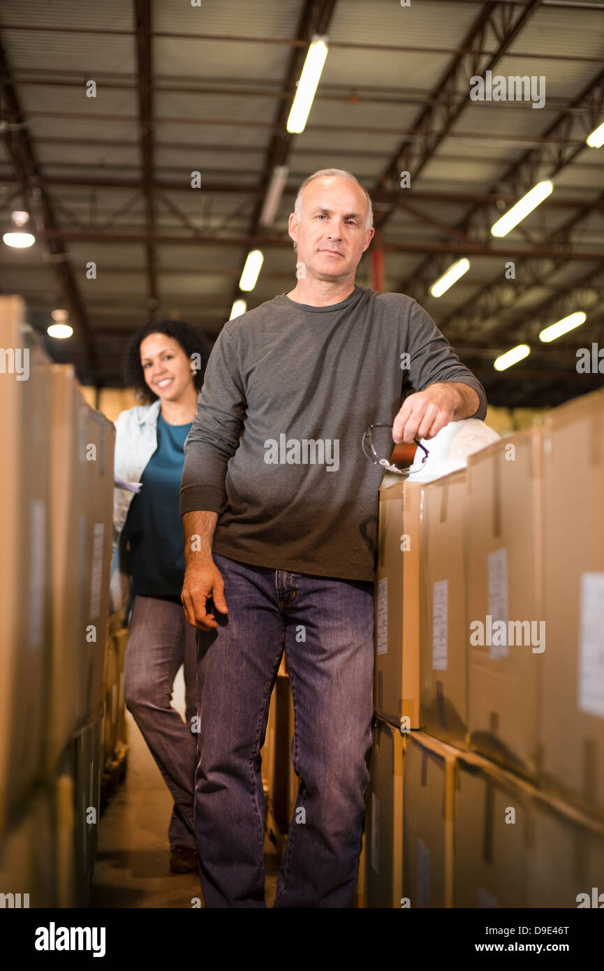 Portrait of warehouse workers by cardboard boxes Stock Photo - Alamy