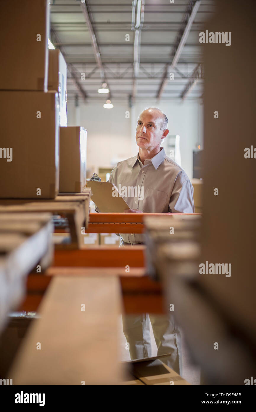 Male warehouse worker doing stock take Stock Photo - Alamy