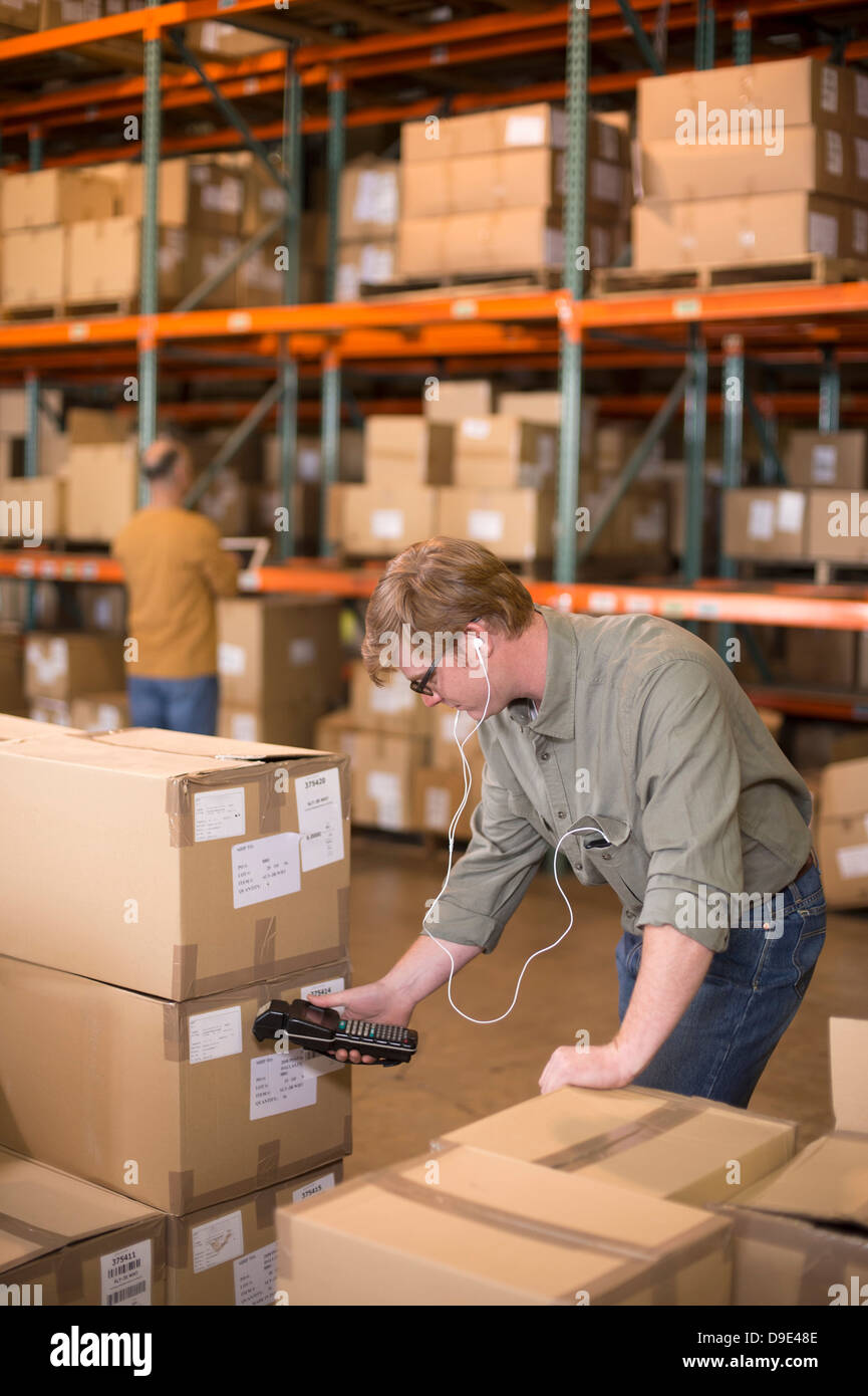 Male warehouse worker using handheld computer Stock Photo - Alamy