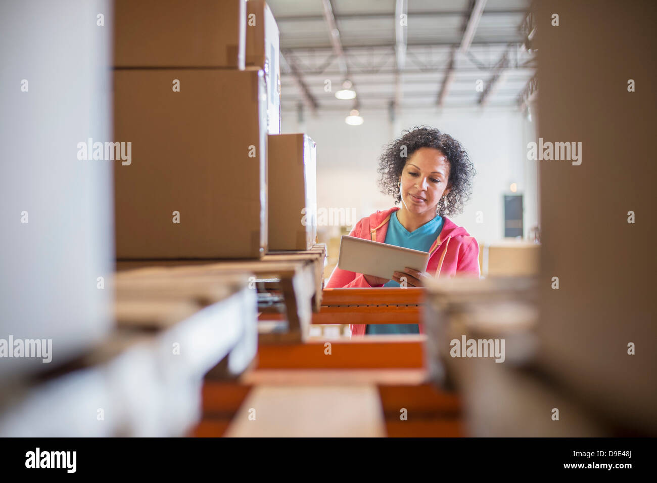 Female warehouse worker doing stock take Stock Photo - Alamy
