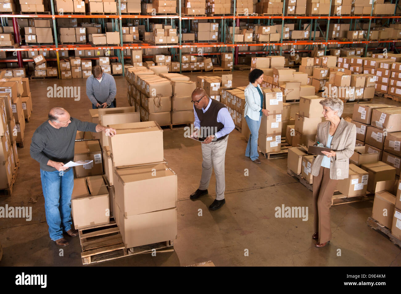 Warehouse workers standing with boxes, high angle Stock Photo - Alamy