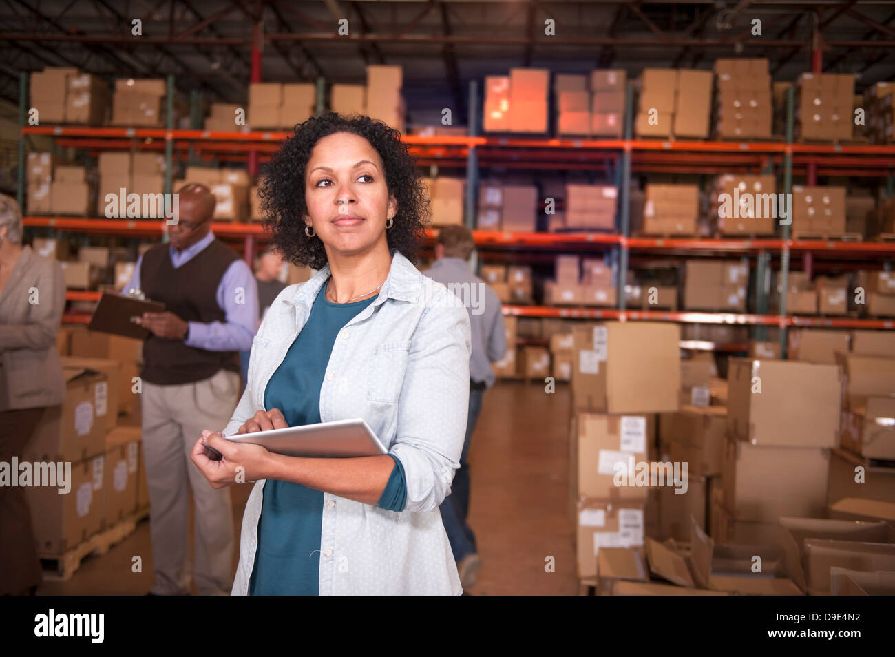 Female warehouse worker using digital tablet Stock Photo - Alamy