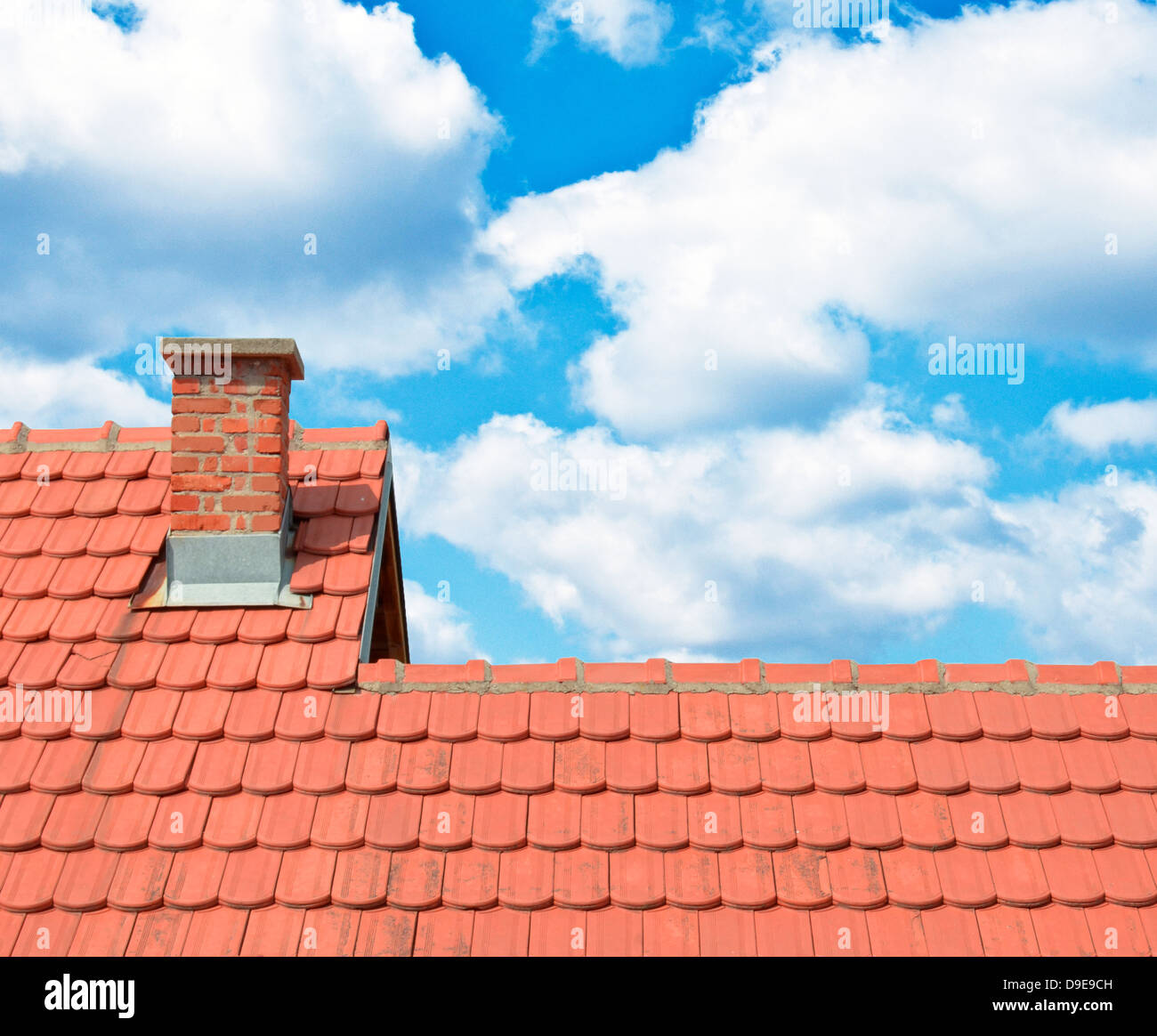 Brand new red rooftop against blue sky Stock Photo - Alamy