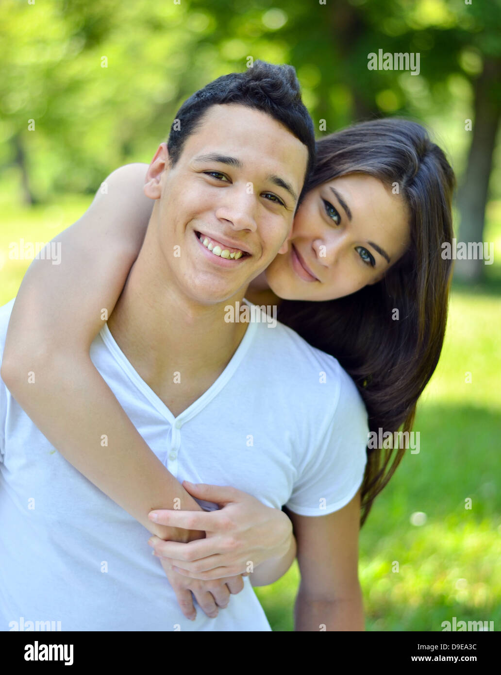 Couple hugging in a park Stock Photo - Alamy