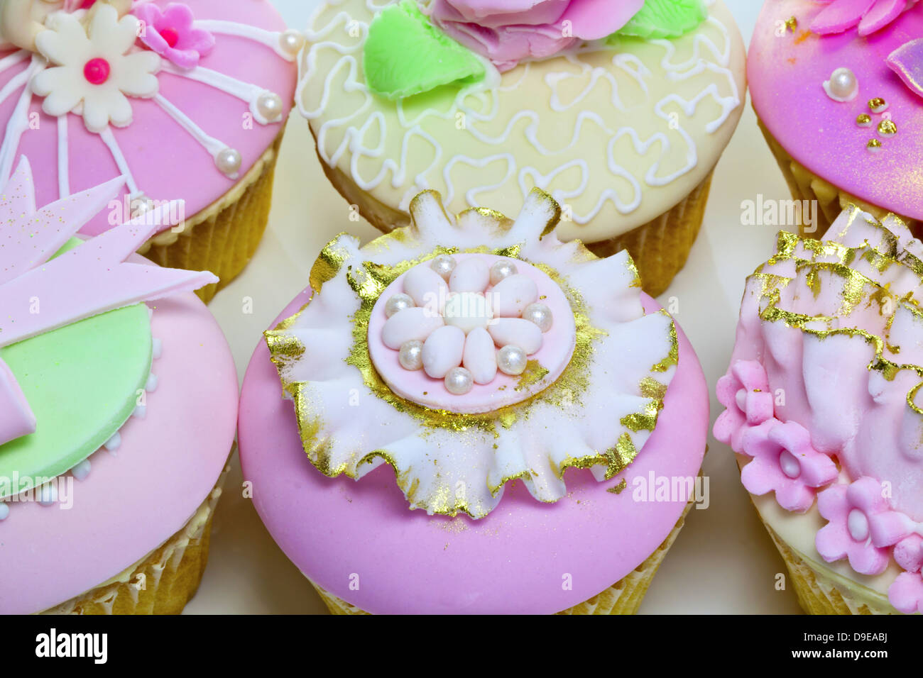 Iced cupcakes in pink, white, blue and gold Stock Photo - Alamy