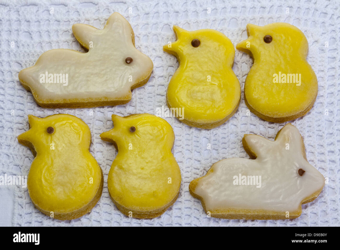 Traditional Easter bunnies and chicks shortbread biscuits on lace ...