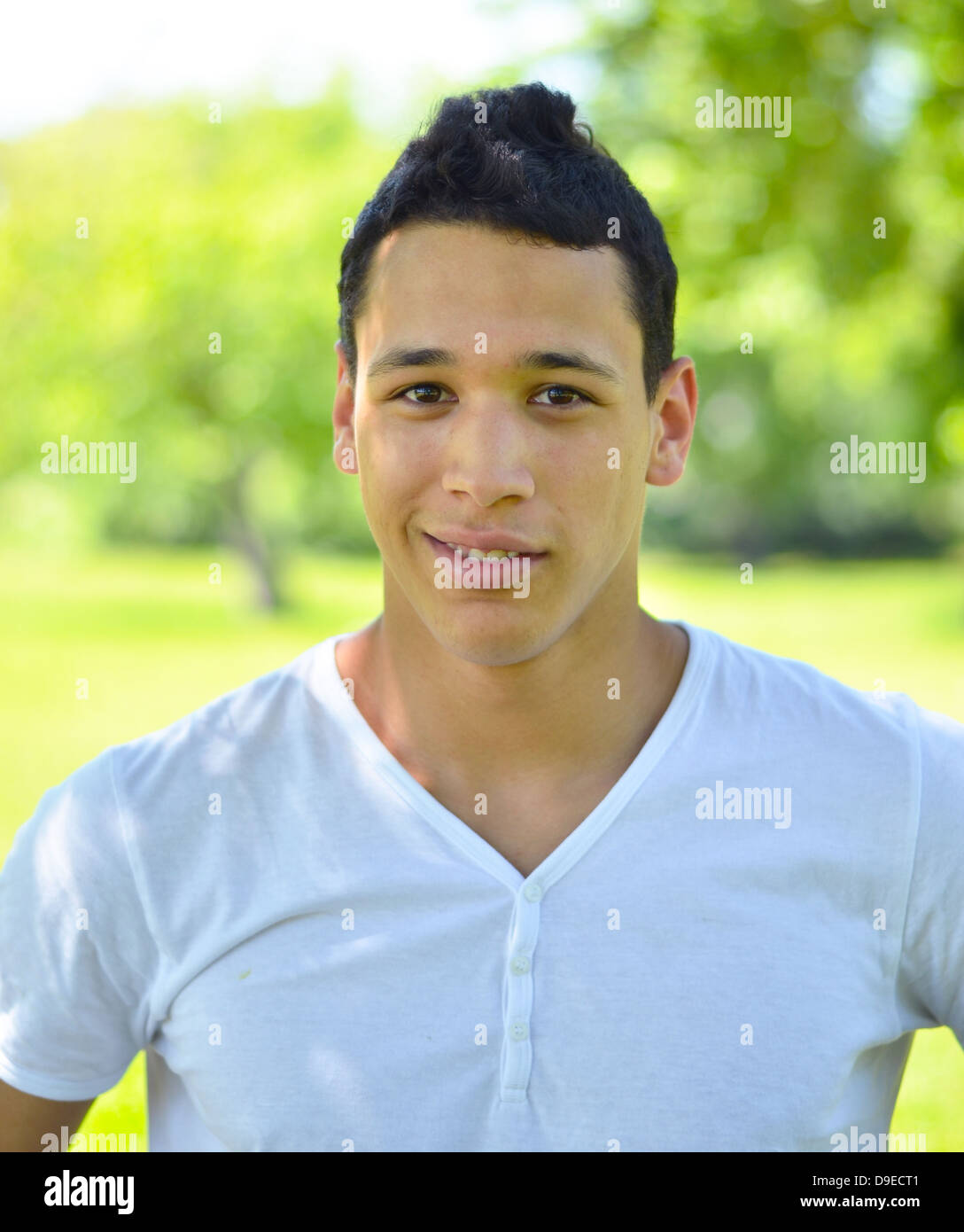 Portrait of happy young man smiling against nature background Stock ...