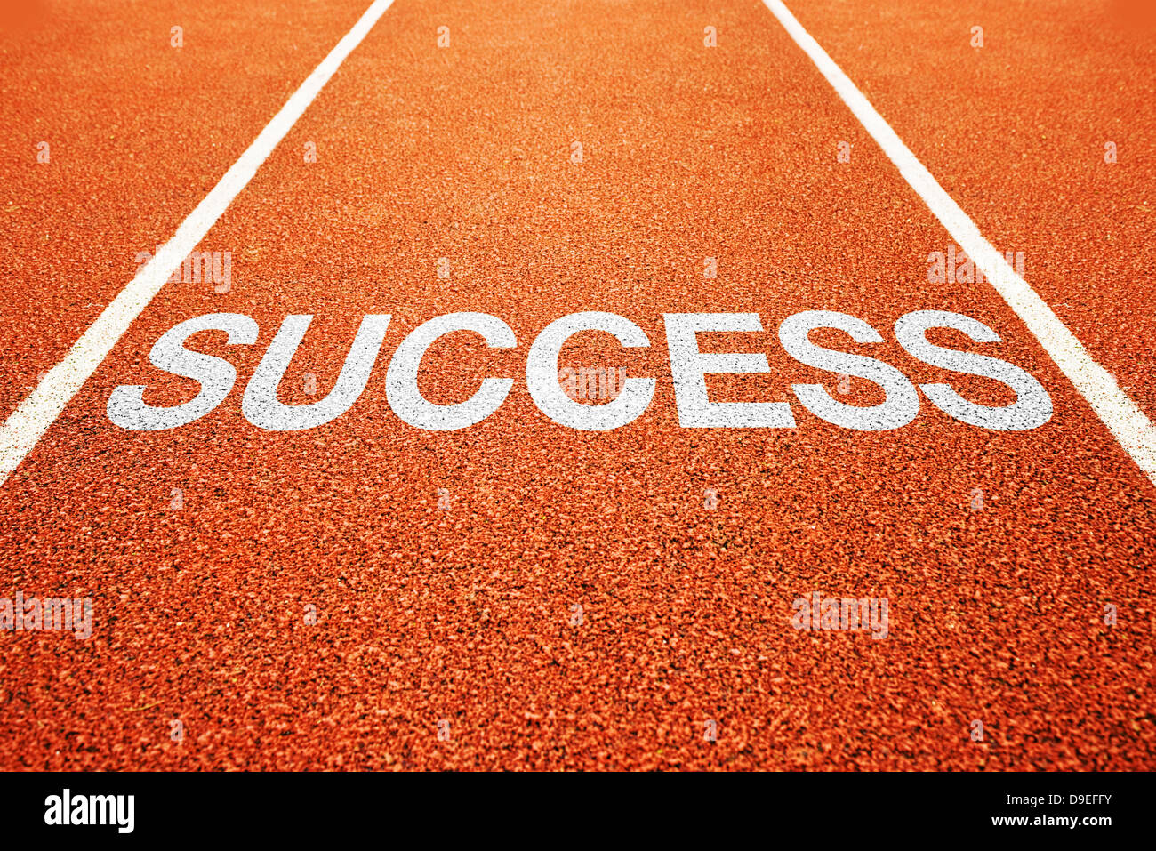 Success on athletics all weather running track Stock Photo - Alamy