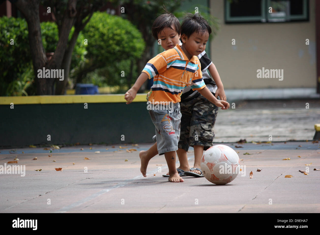 two kids fighting for the ball Stock Photo - Alamy