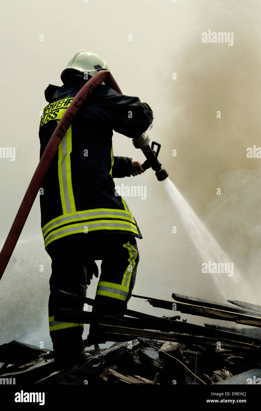 Firefighter in use application Stock Photo - Alamy