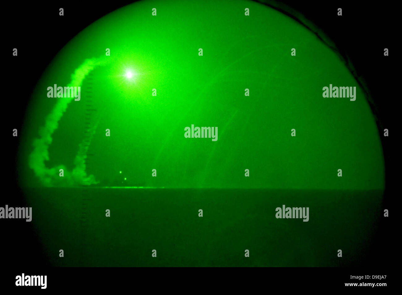 A Tomahawk cruise missile fired from USS Barry as seen through night ...