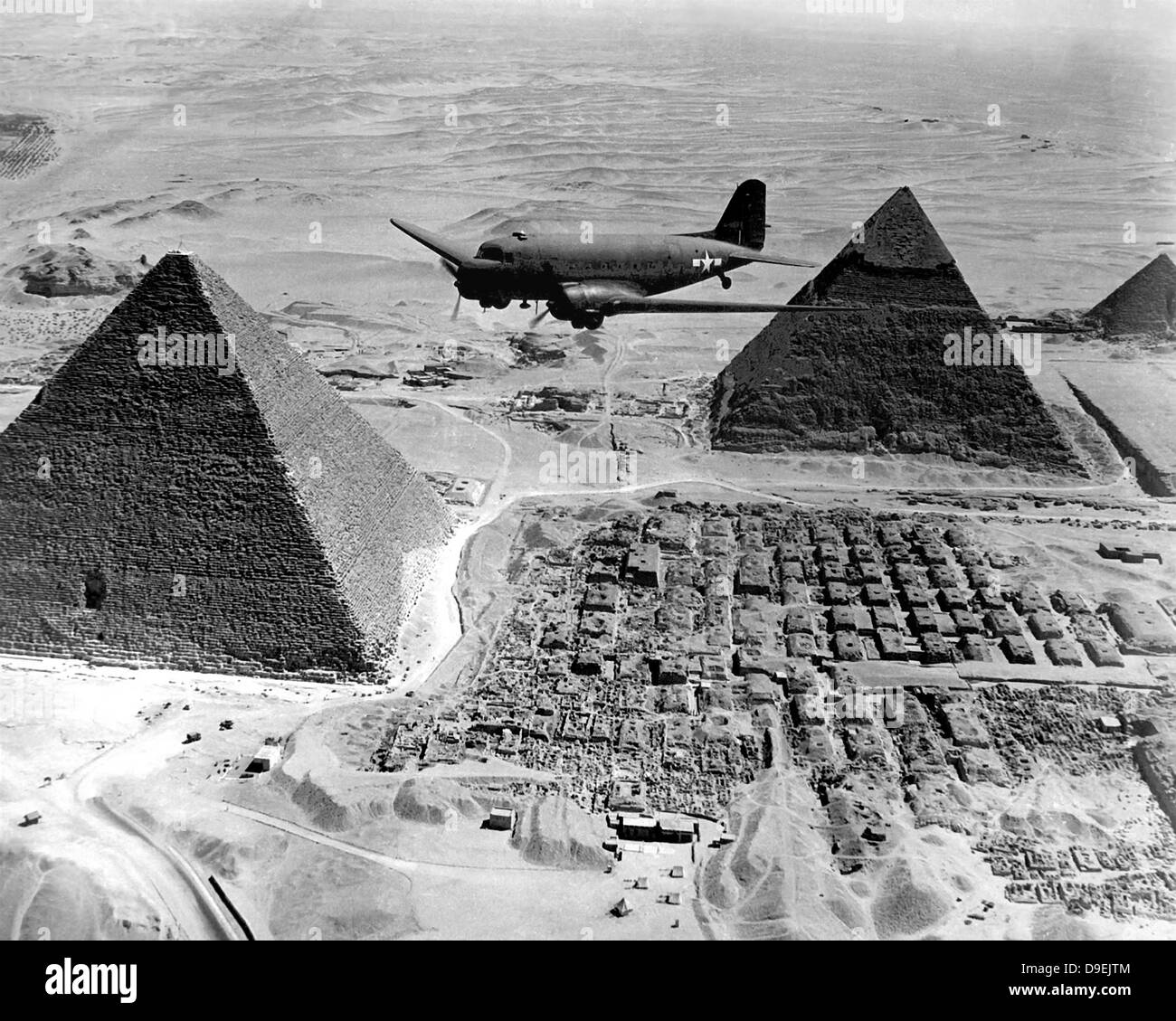 An Air Transport Command plane flies over the pyramids in Egypt Stock ...
