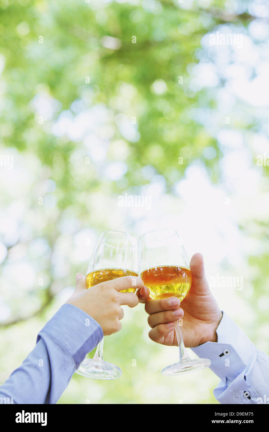 Couple cheering with white wine Stock Photo - Alamy