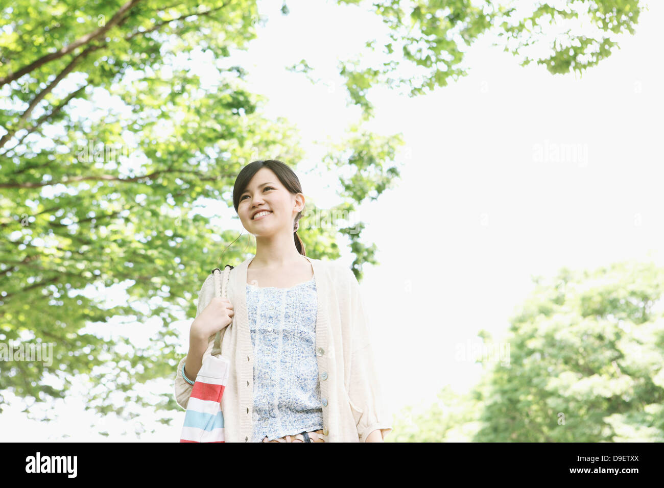 Young woman smiling away Stock Photo - Alamy