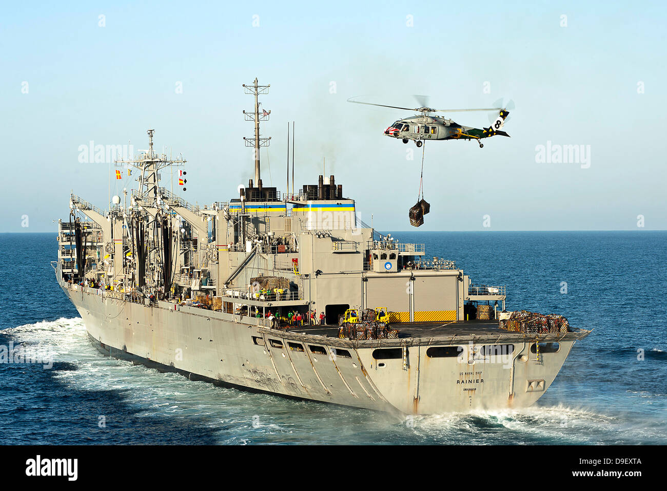 An MH-60S Knighthawk lifts cargo from the fast combat support ship USNS ...