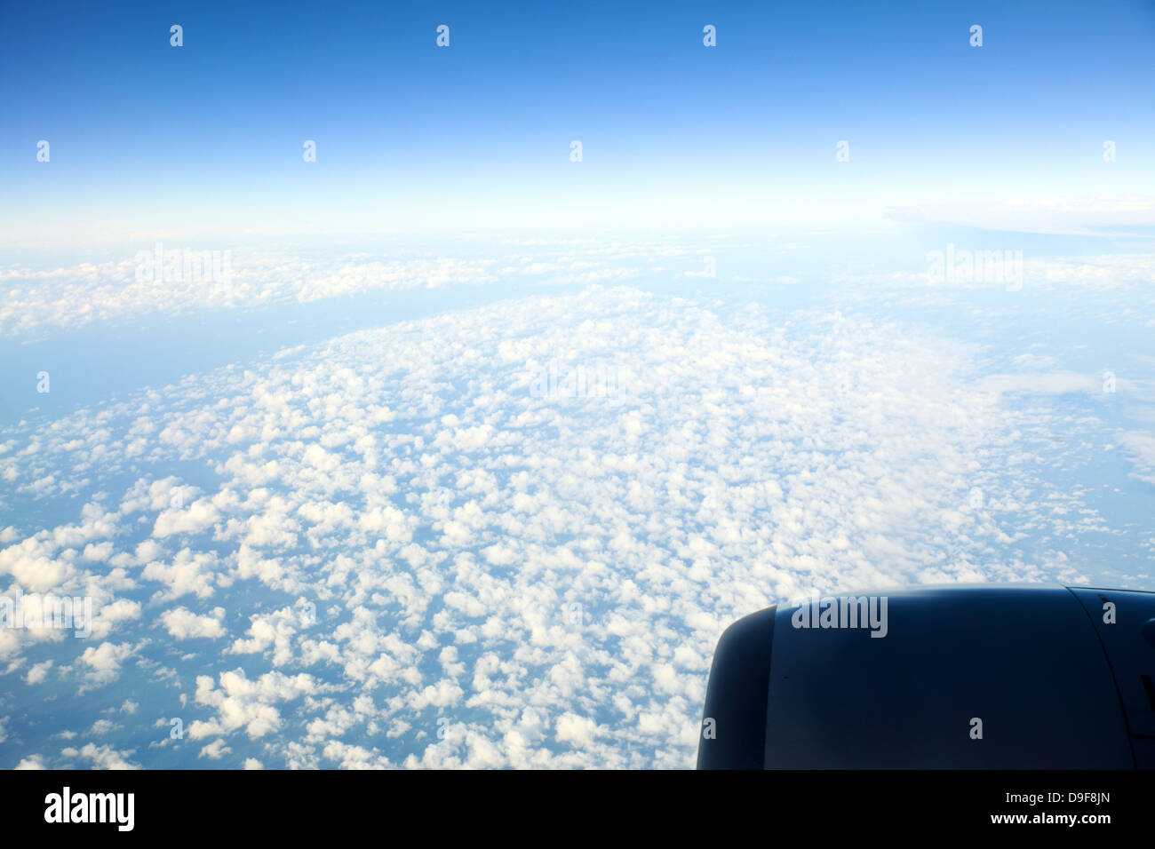 Airplane in the blue sky engine and white clouds Stock Photo - Alamy