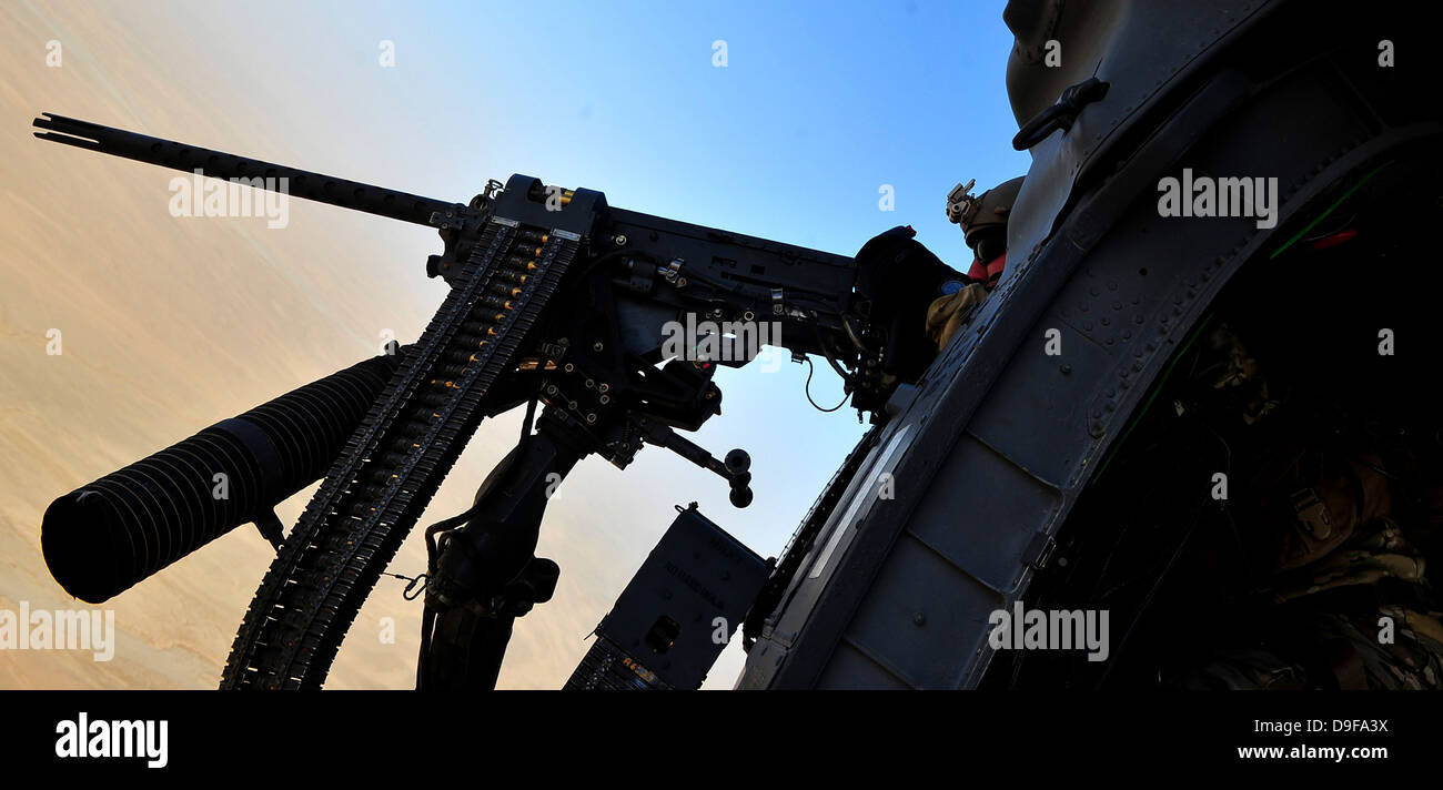 Soldier mans the .50 caliber machine gun on a HH-60G Pave Hawk Stock ...