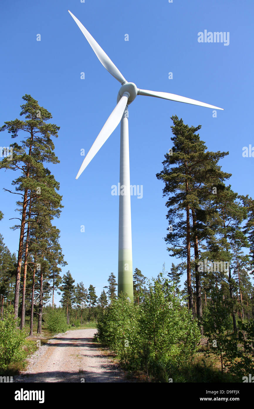 Wind turbine in pine forest near Hanko, Finland, on a bright day at ...
