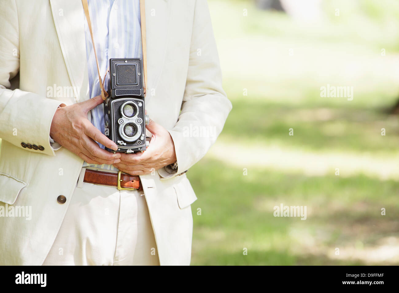 Senior man with vintage camera Stock Photo - Alamy