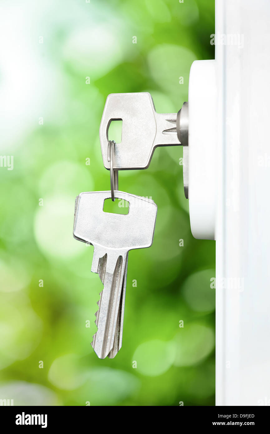 Keys in door lock, summer defocus background Stock Photo - Alamy