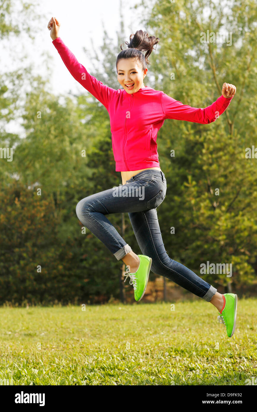 young woman jumping Stock Photo - Alamy