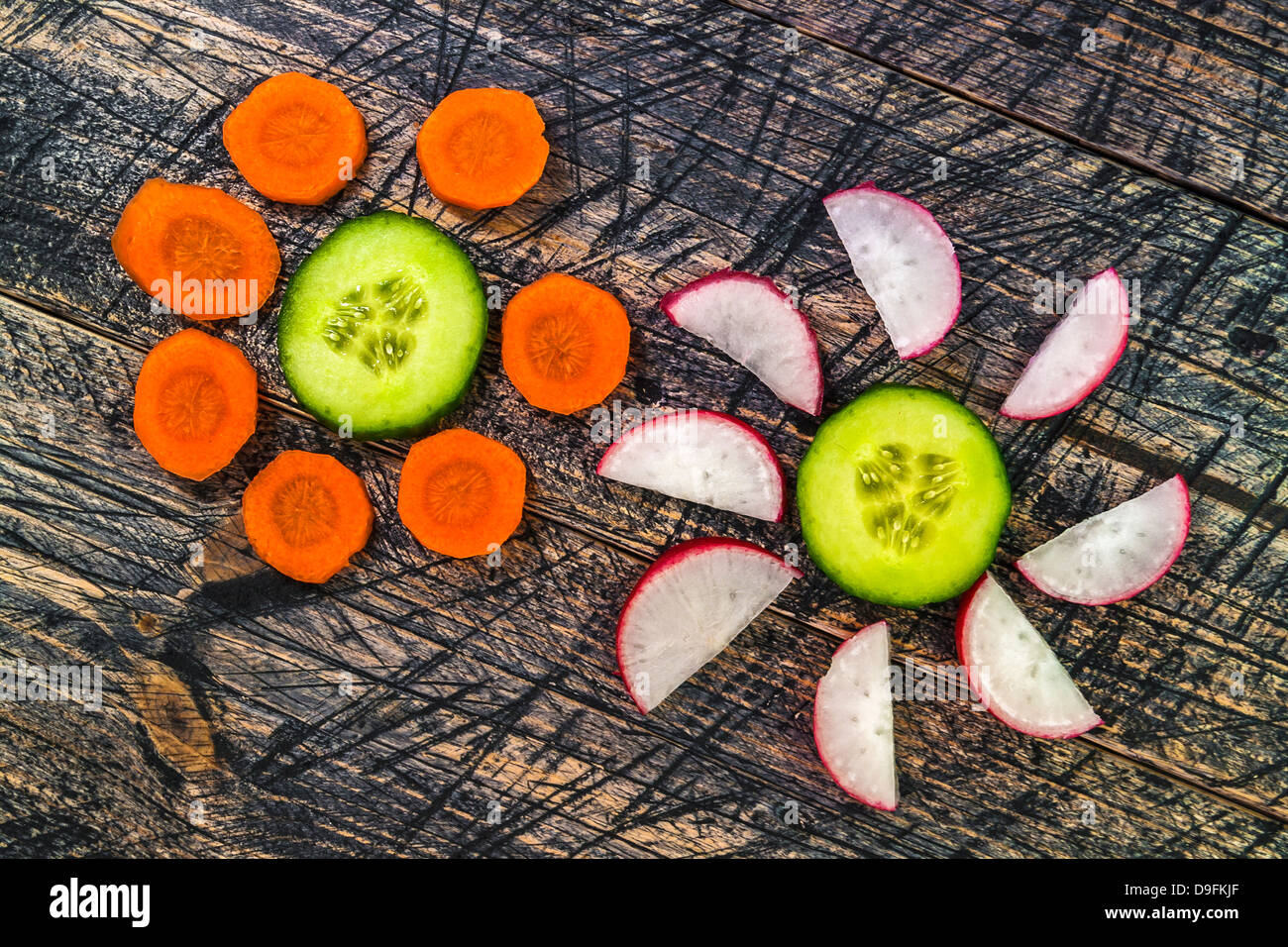 Composition with early vegetables on wooden board Stock Photo - Alamy