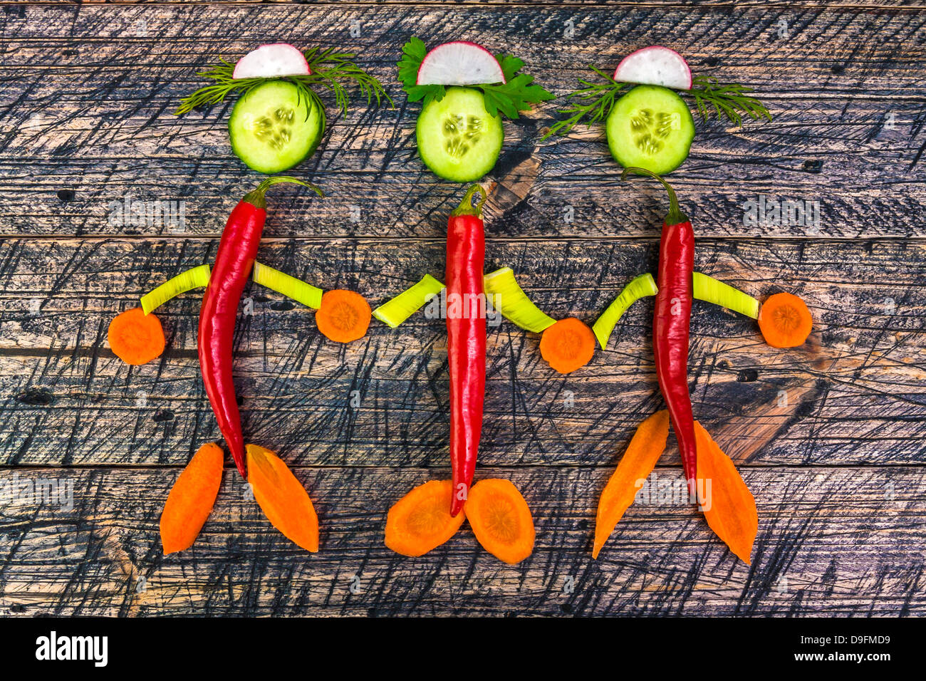 Composition with early vegetables on wooden board Stock Photo - Alamy