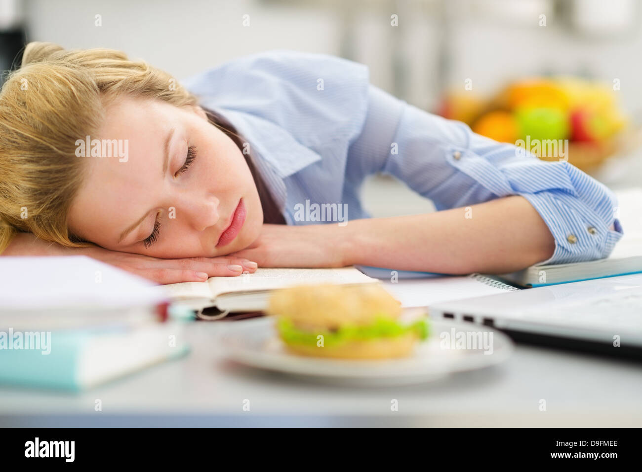 Teenage girl fall asleep while studying in kitchen Stock Photo - Alamy