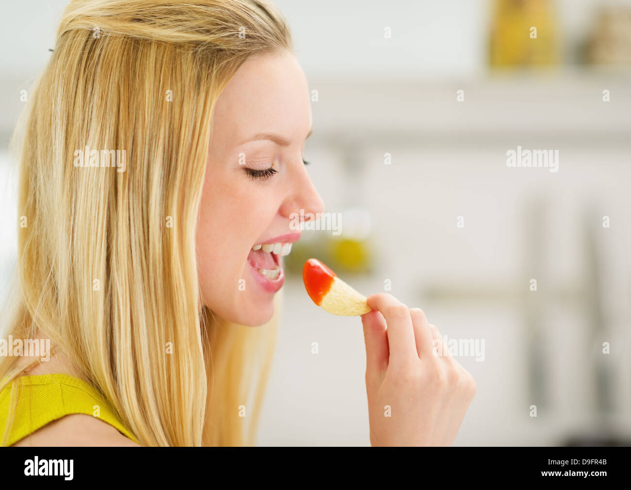 Girl eating chips ketchup hi-res stock photography and images - Alamy