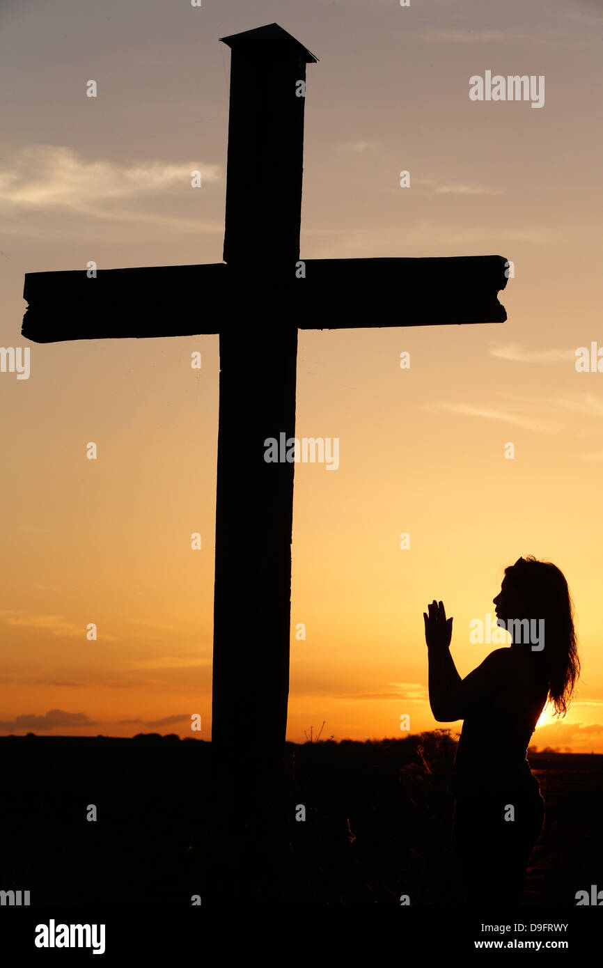 Woman praying at sunset hi-res stock photography and images - Alamy