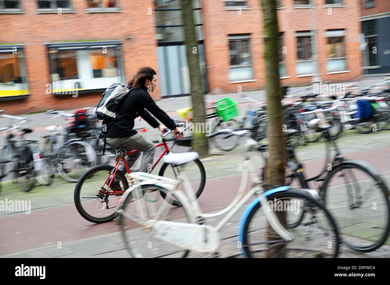Man riding bicycle in amsterdam hi-res stock photography and images - Alamy