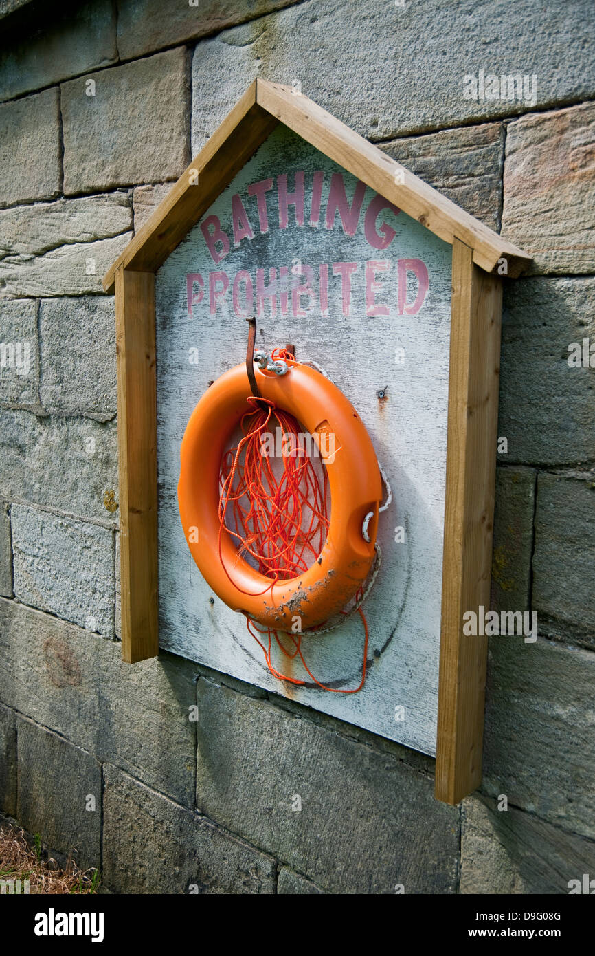 Close up of Bathing prohibited no swimming sign with a lifebuoy ...