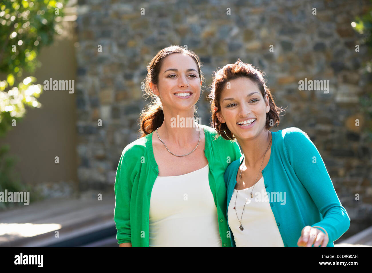 Two female friends smiling together Stock Photo - Alamy