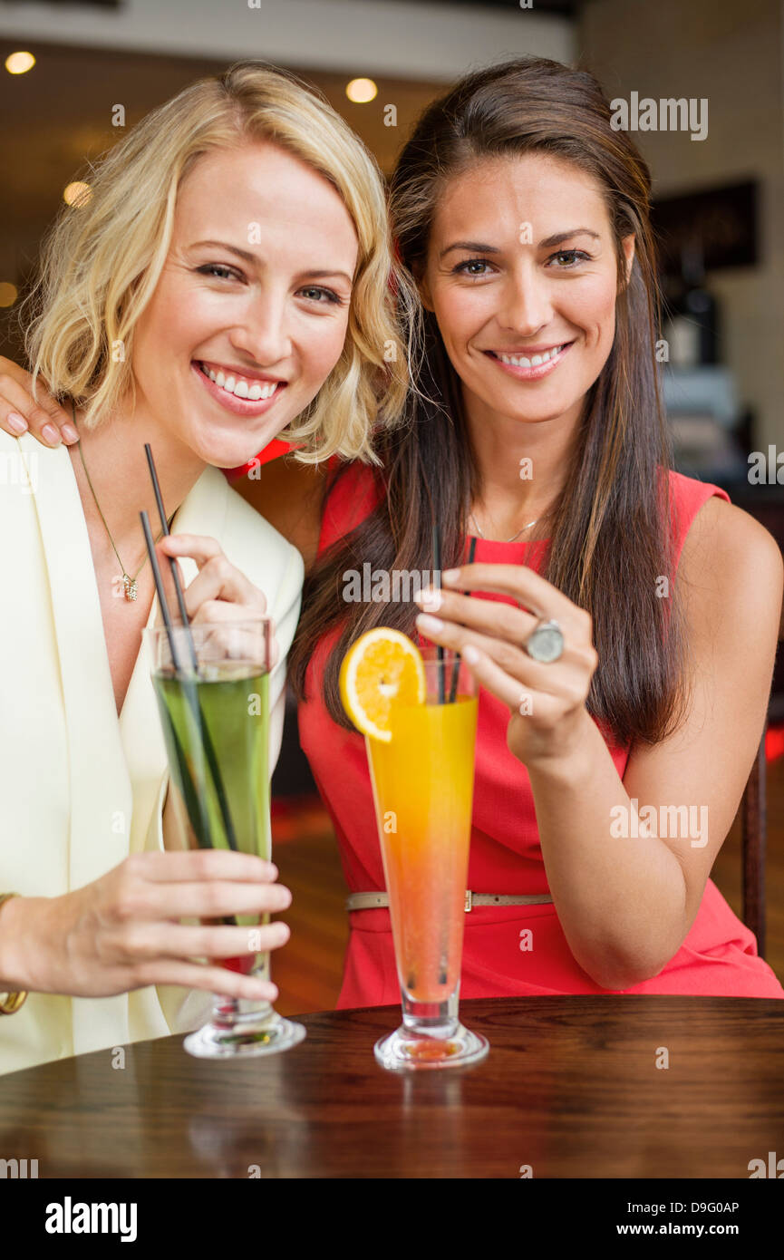 Two female friends enjoying drinks in a restaurant Stock Photo - Alamy