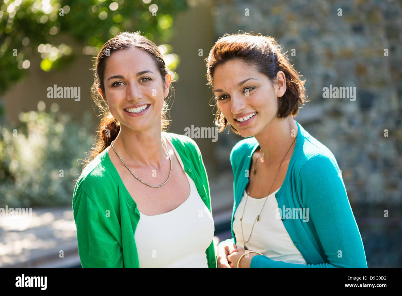 Two female friends smiling together Stock Photo - Alamy