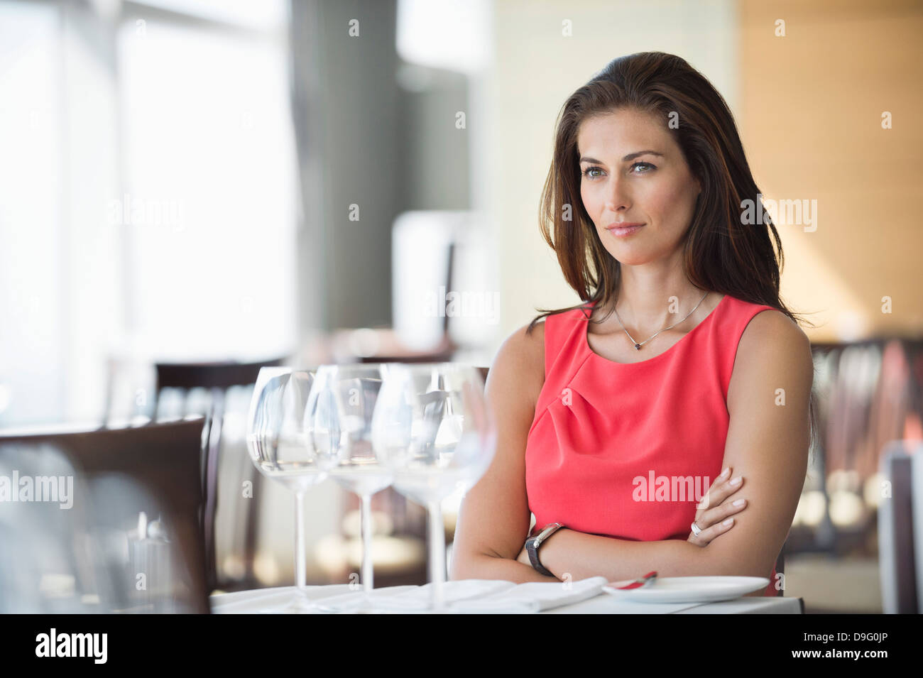 Woman sitting in a restaurant and thinking Stock Photo - Alamy