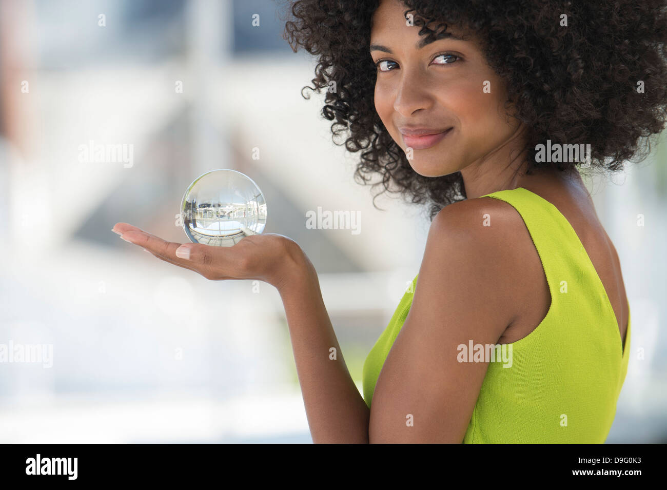 Portrait of a woman holding a crystal ball Stock Photo - Alamy