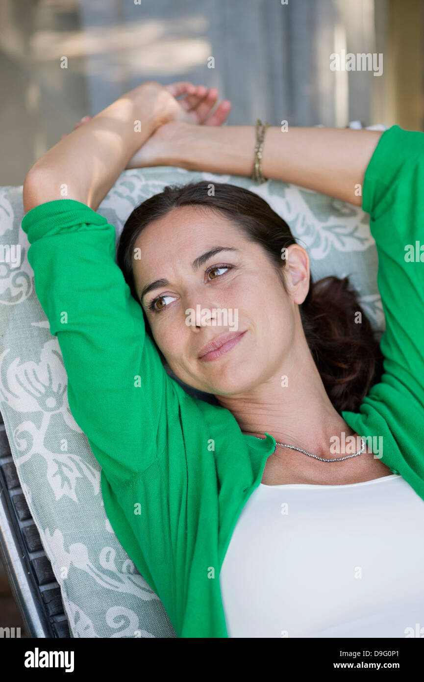 Woman relaxing on a lounge chair Stock Photo - Alamy