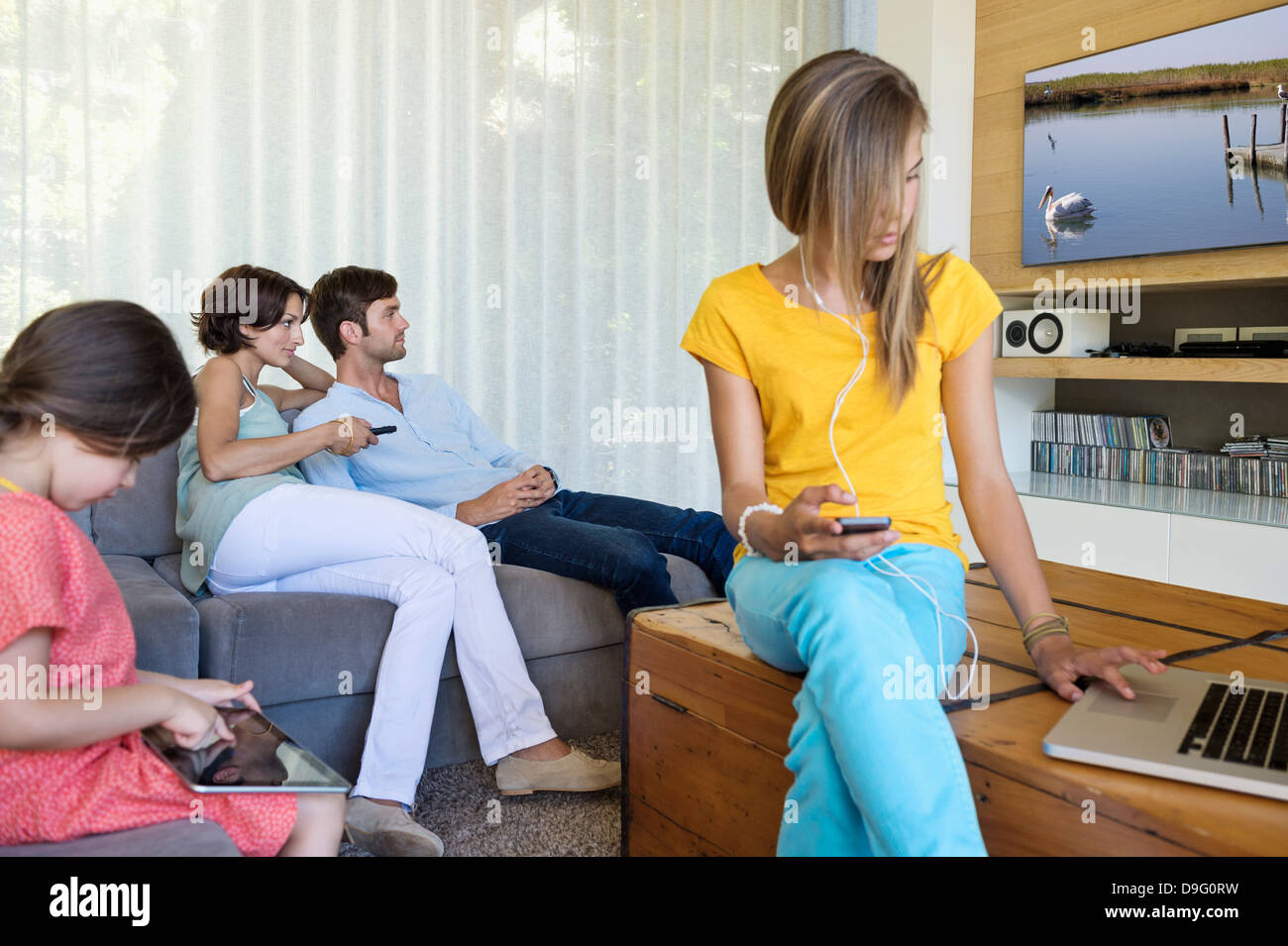 Family using electronics gadgets Stock Photo - Alamy