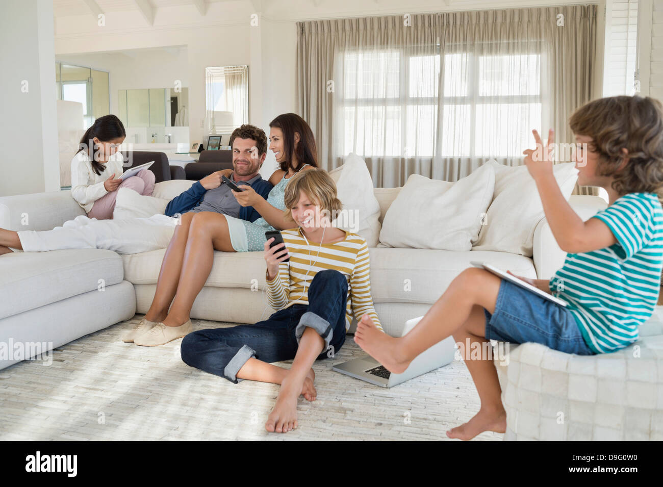Family using electronics gadget Stock Photo - Alamy