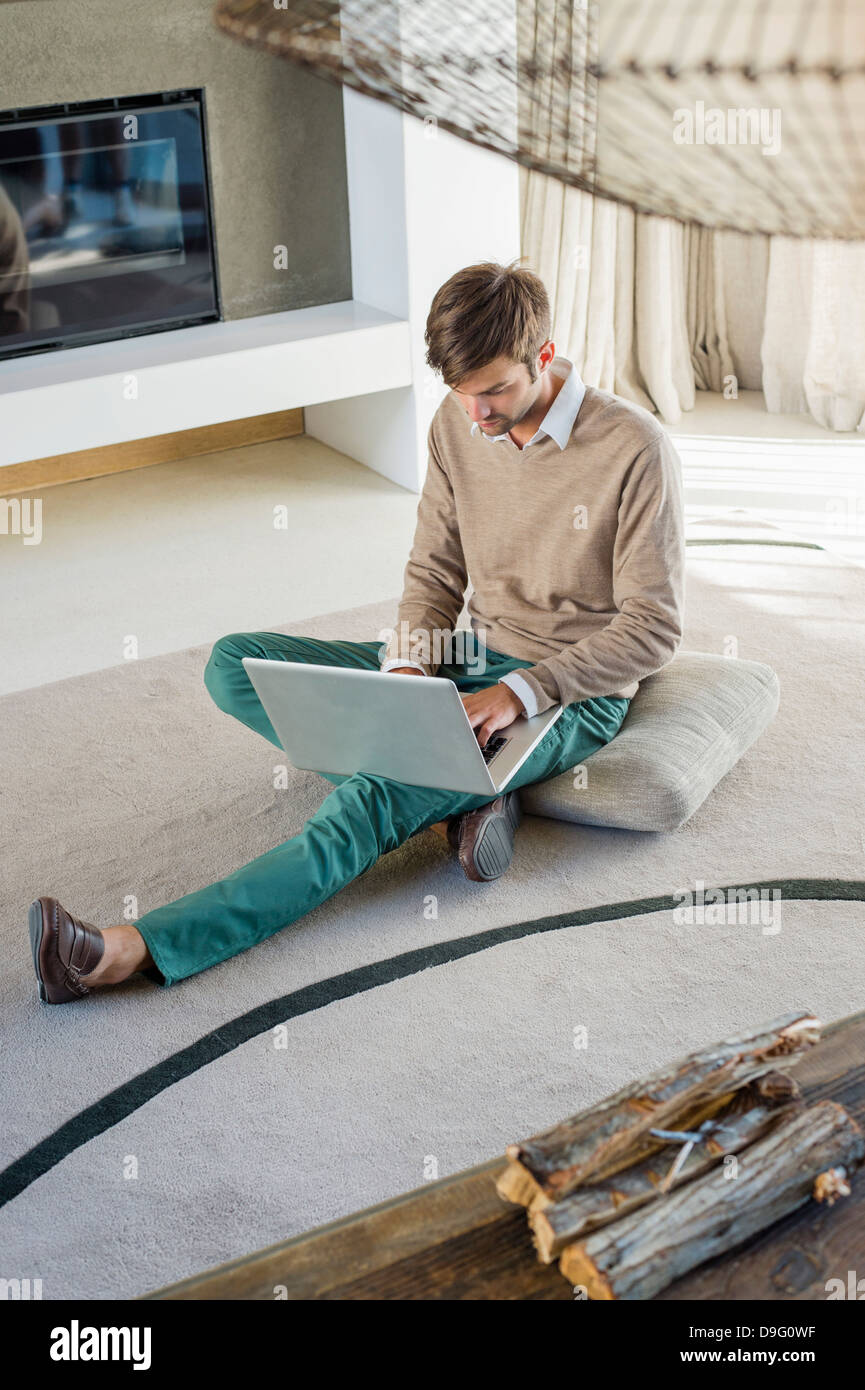 Man using a laptop at home Stock Photo - Alamy