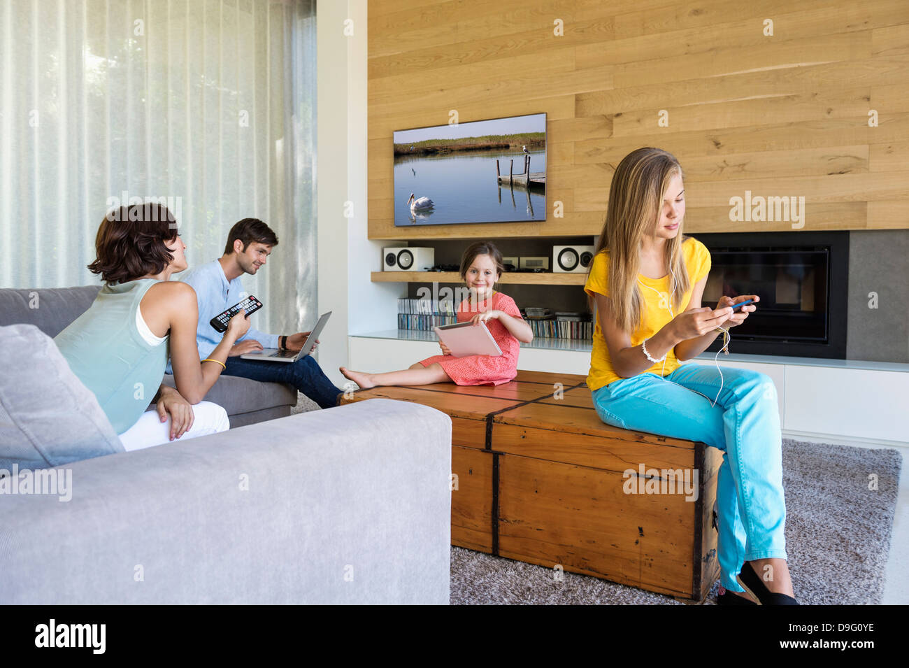 Family using electronics gadgets Stock Photo - Alamy