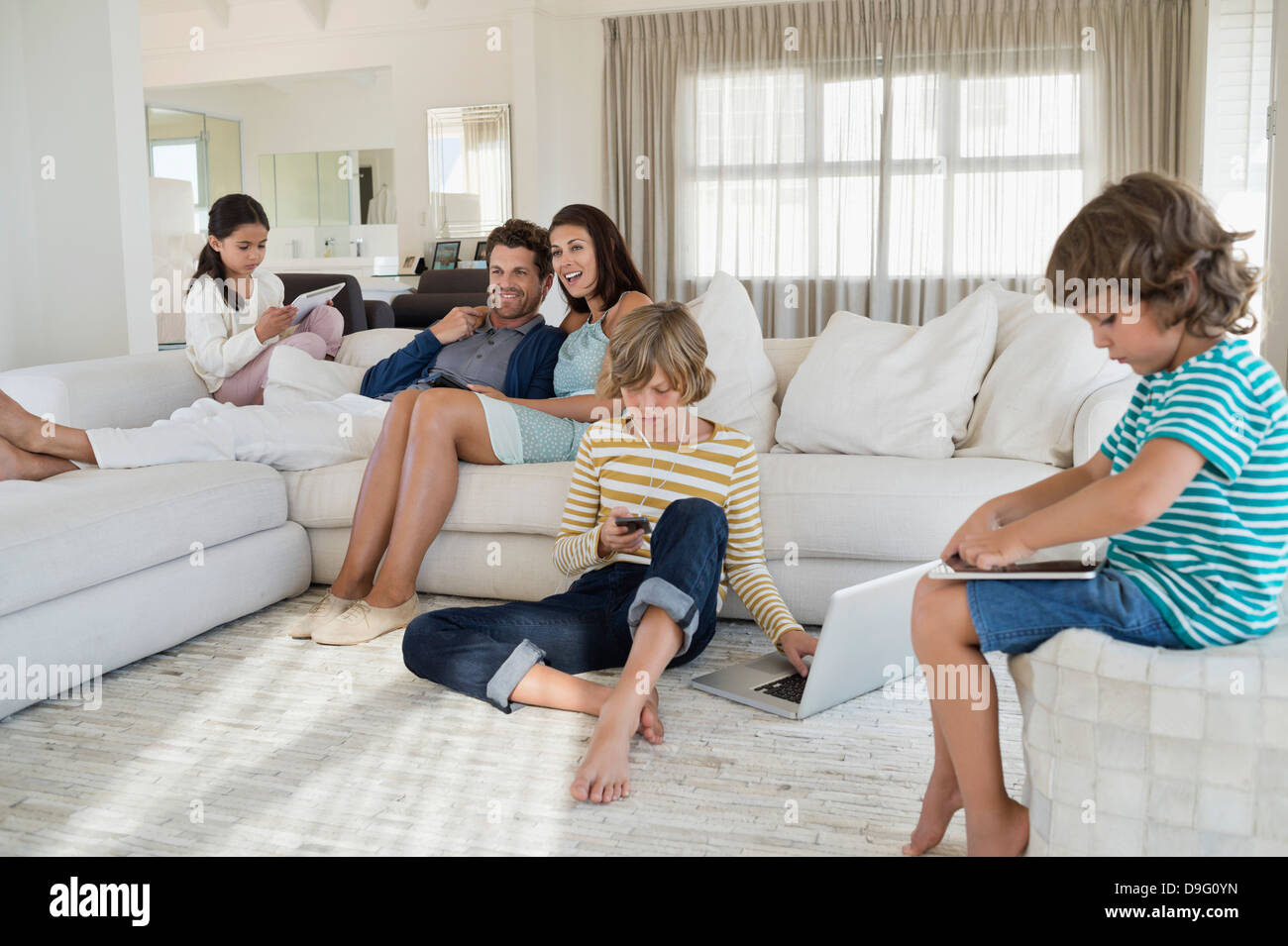 Family using electronics gadget Stock Photo - Alamy