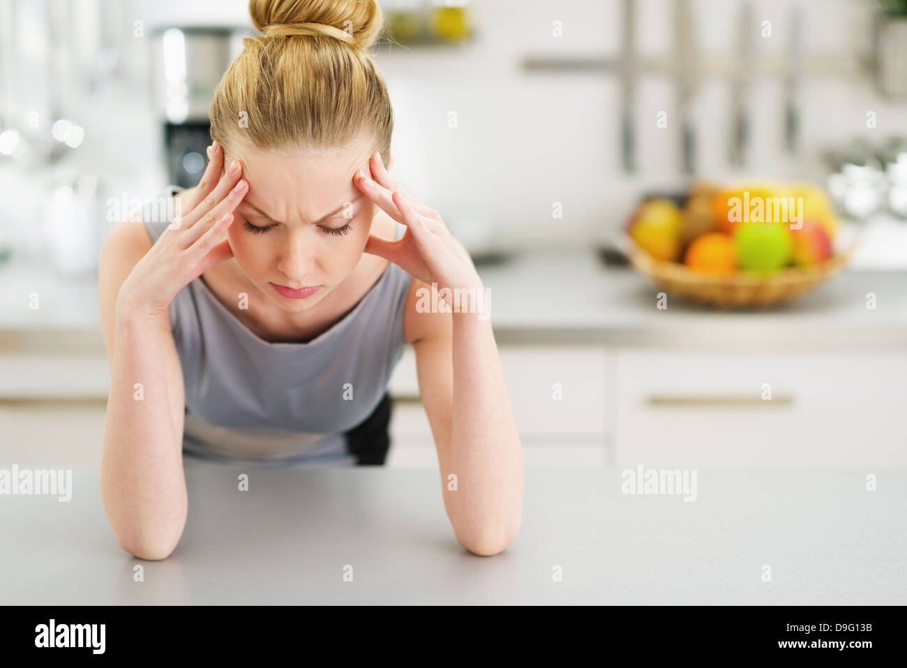 Portrait of stressed young housewife in modern kitchen Stock Photo - Alamy