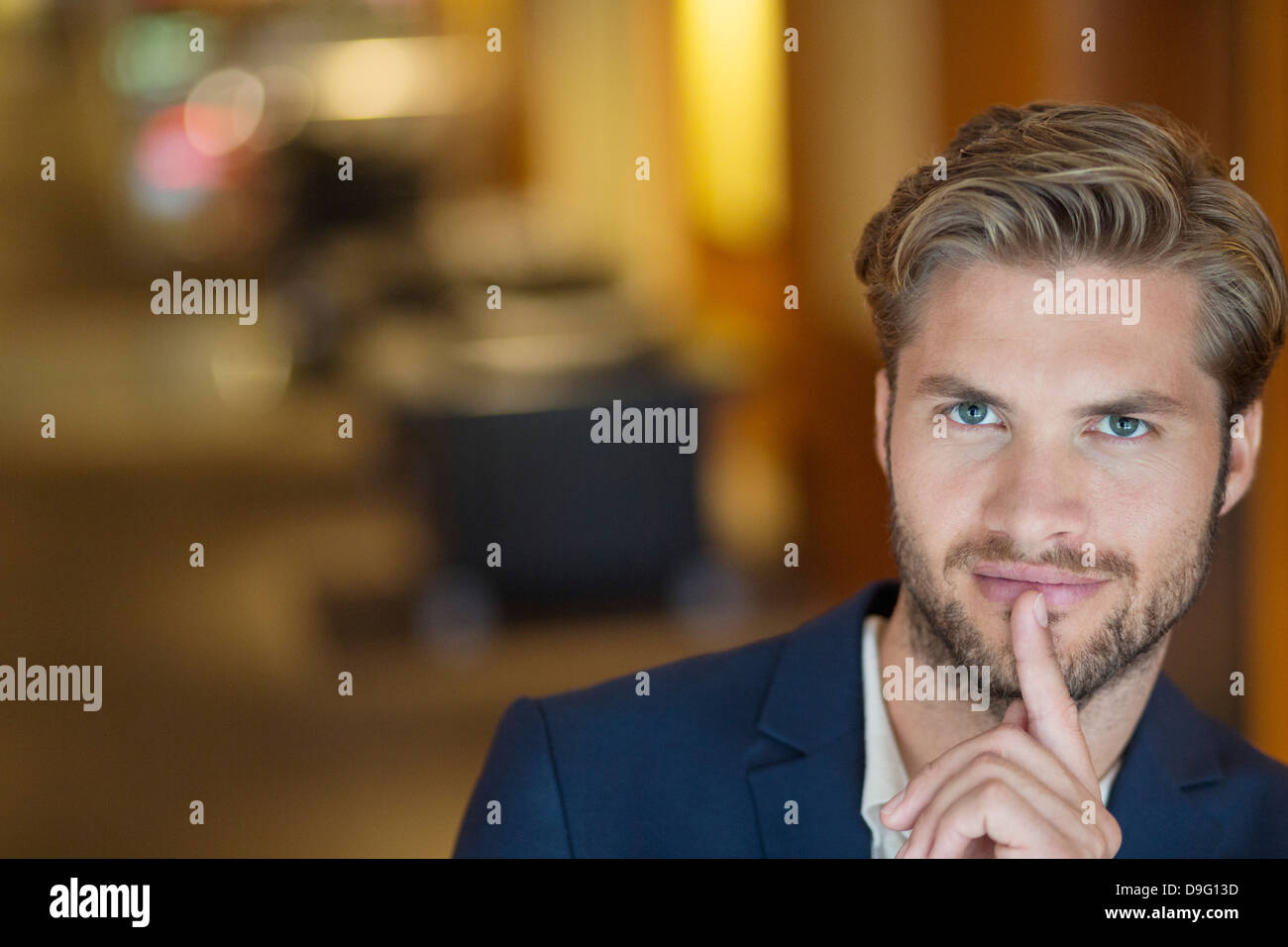 Portrait of a man with his finger on lips Stock Photo - Alamy