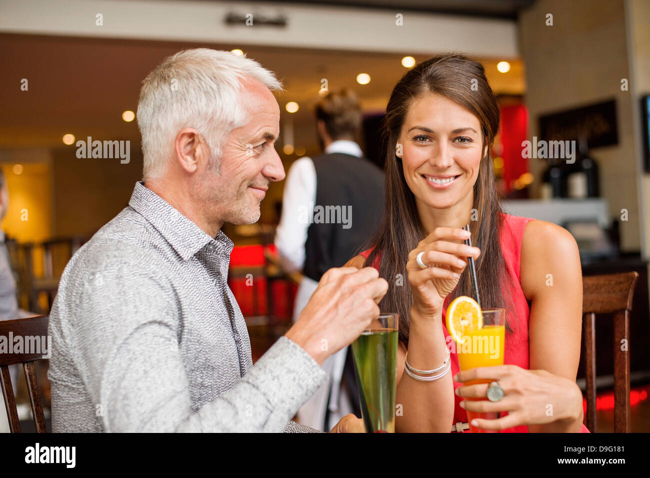 Couple enjoying drinks in a restaurant Stock Photo - Alamy