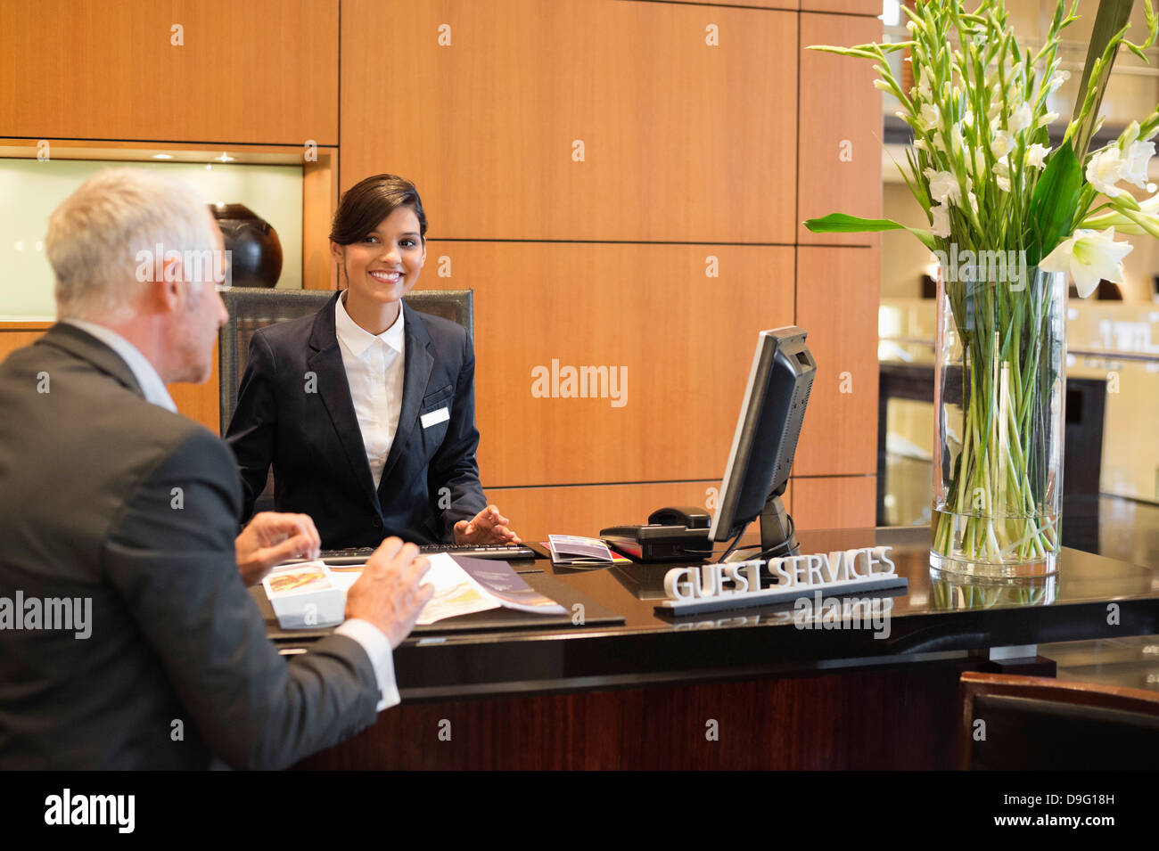 Businessman woman sitting reception desk hi-res stock photography and ...