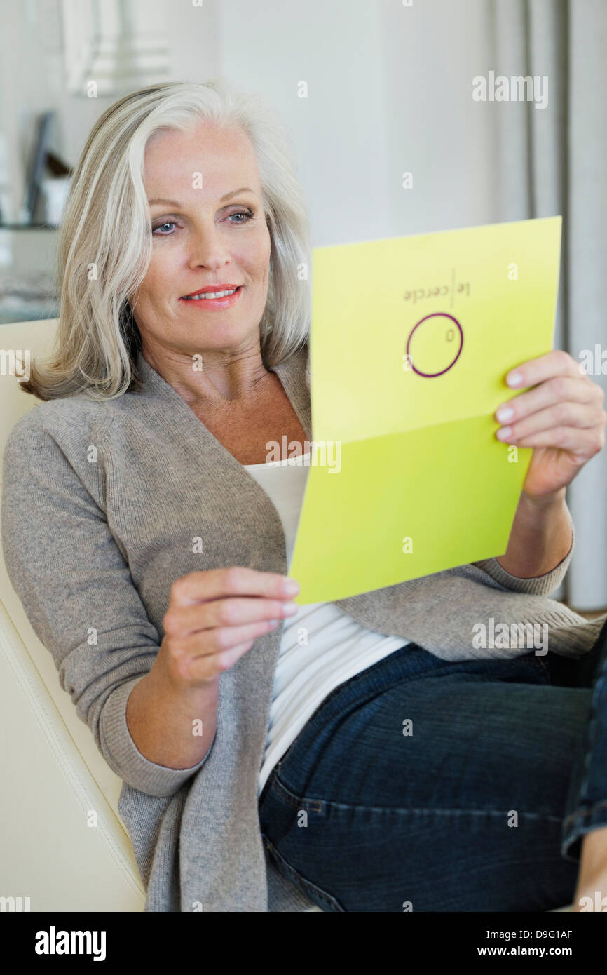 Senior woman reading a greeting card Stock Photo - Alamy