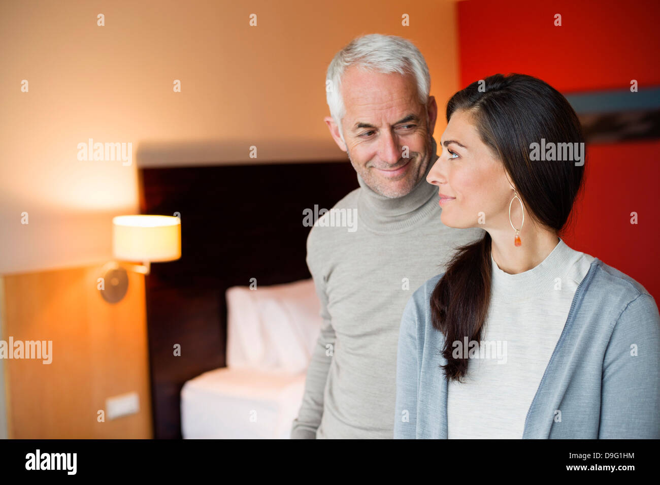 Couple smiling in a hotel room Stock Photo - Alamy