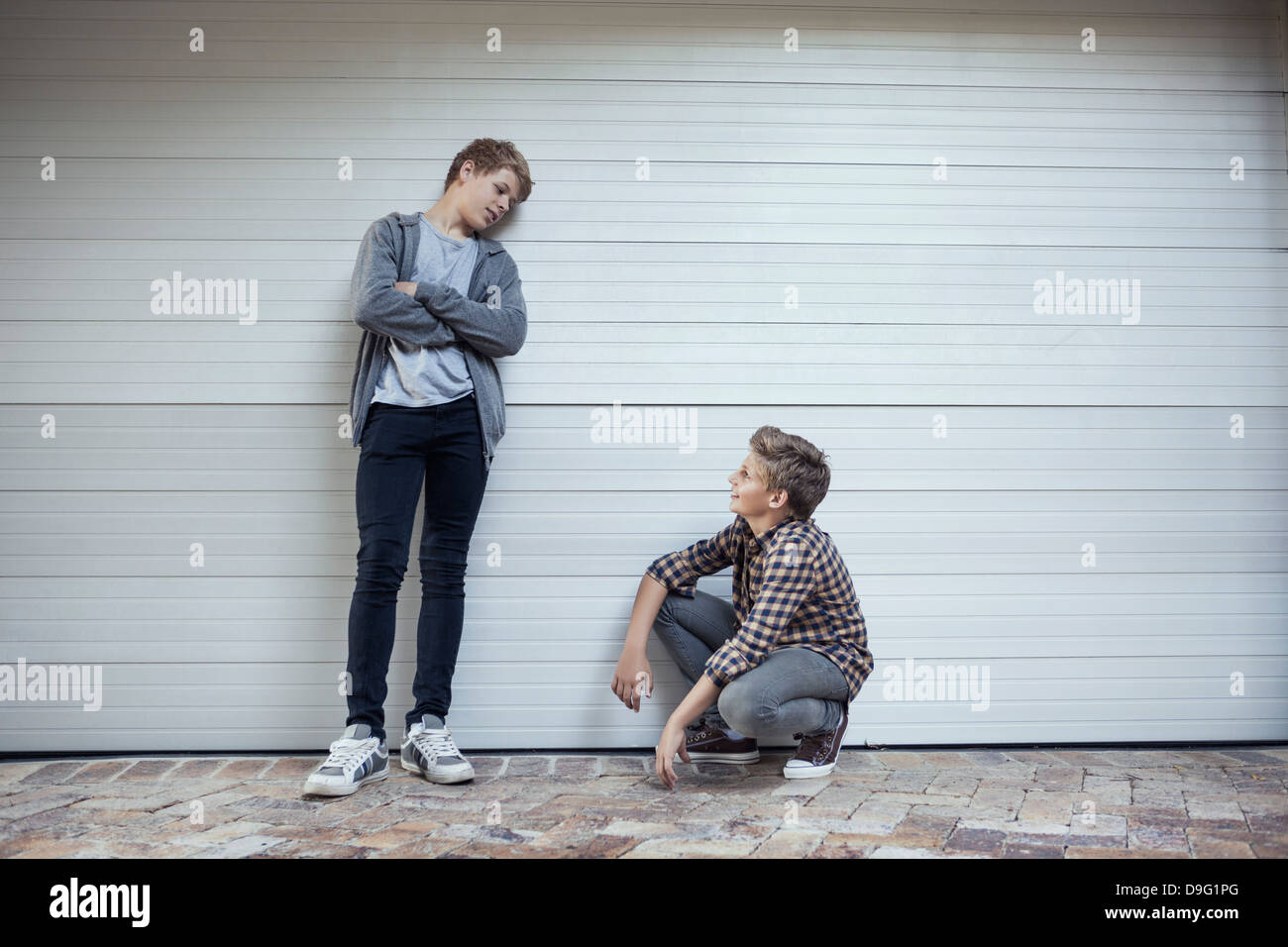 Two teenage boys looking at each other and discussing Stock Photo - Alamy